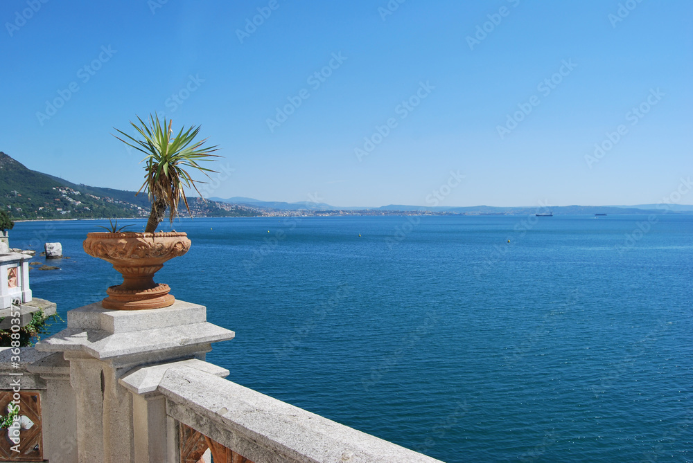 stone parapet of a terrace overlooking the sea with terracotta pot in ...