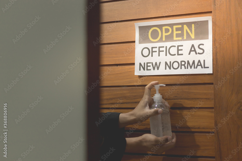 Business owner wears masks to label for open office. The concept is ...