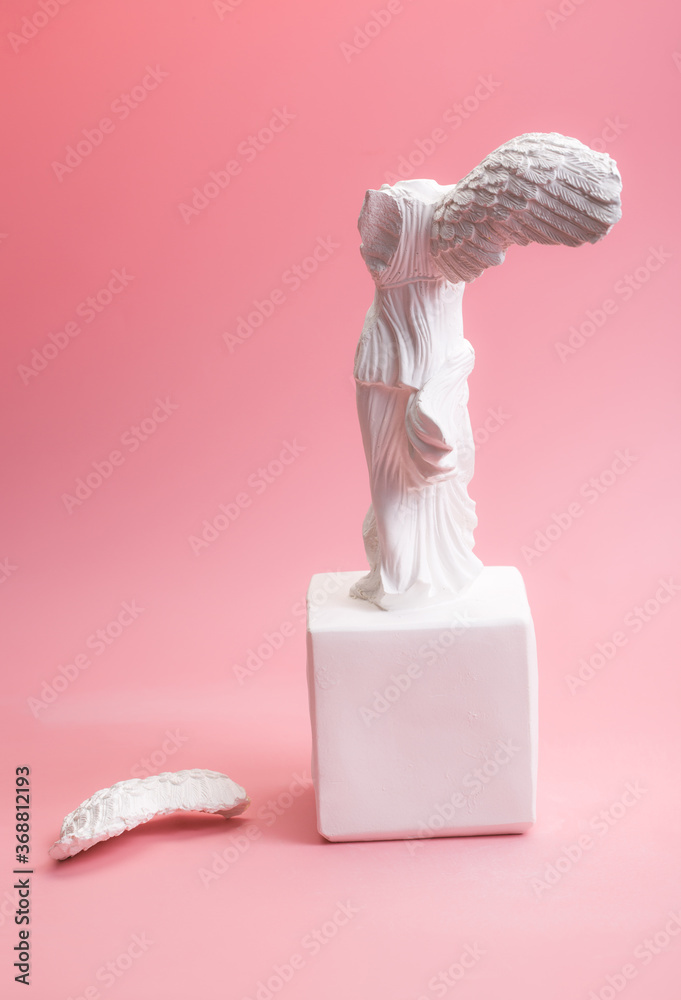 Greek goddess of victory sculpture on pink background Stock Photo ...