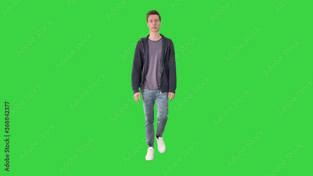 Young attractive student walking forward on a Green Screen, Chroma Key ...