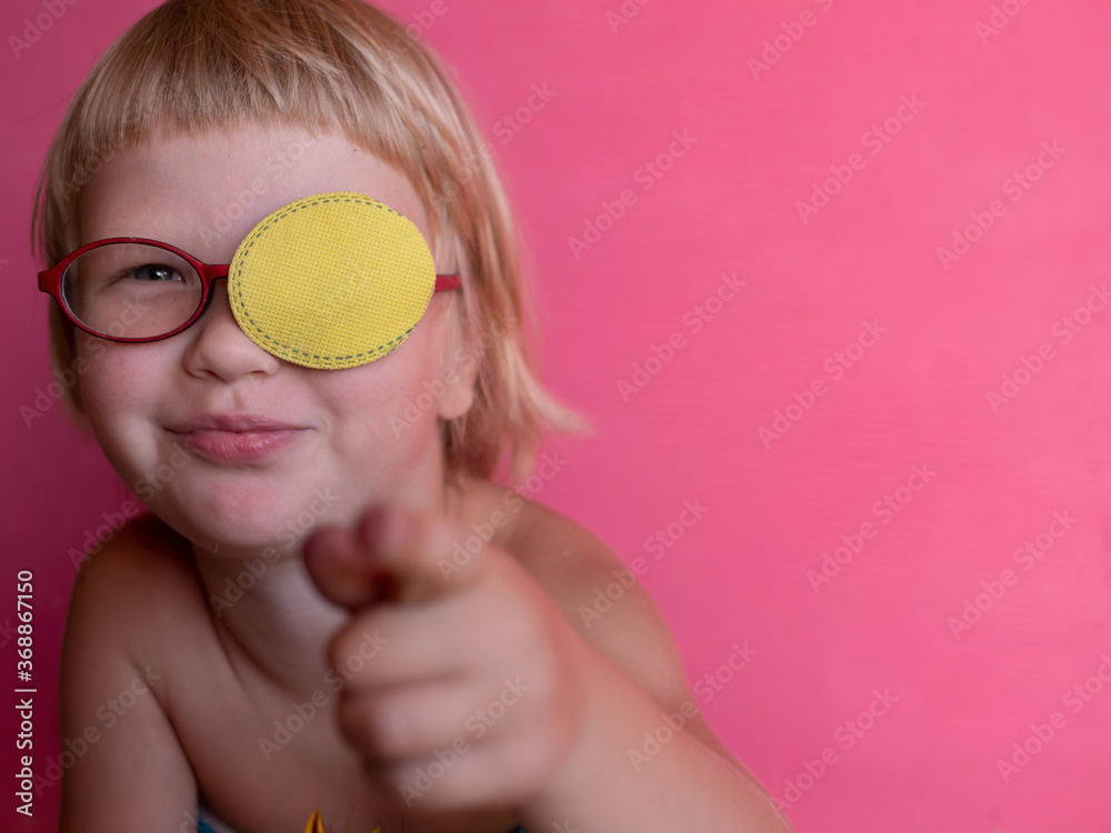 Foto de Portrait of a funny child wearing new glasses with squint patch ...