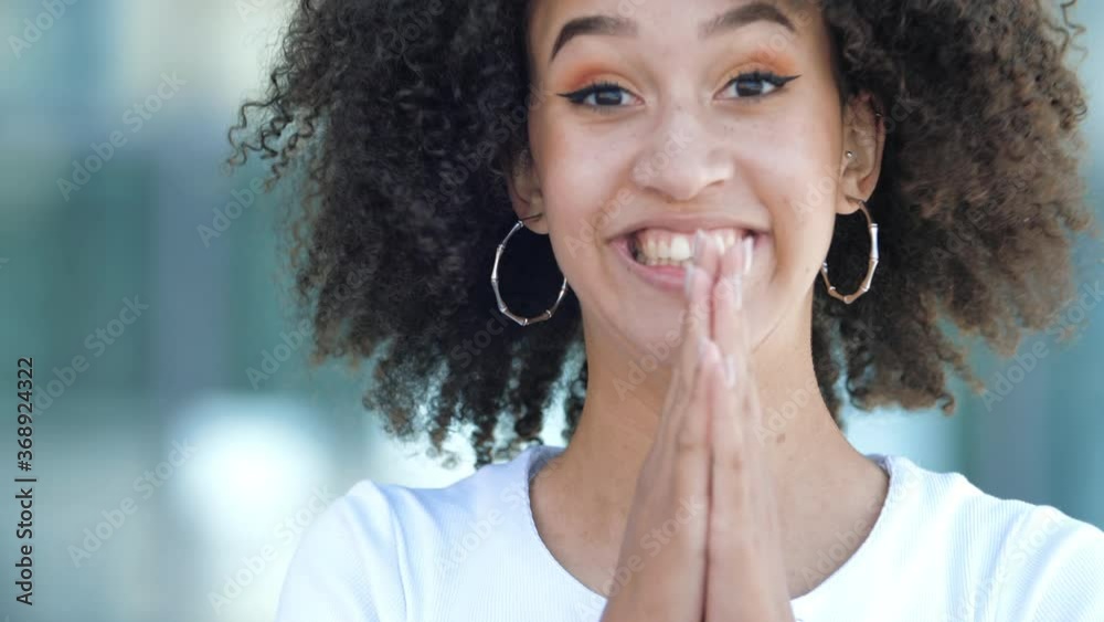 Excited American girl opens her eyes in surprise, presses hands to head ...