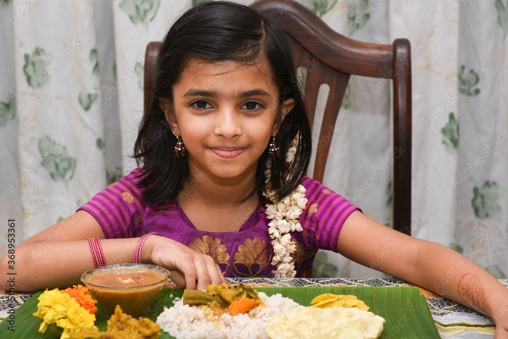 Kerala Onam festival, happy Indian girl child eating Onam sadhya with ...