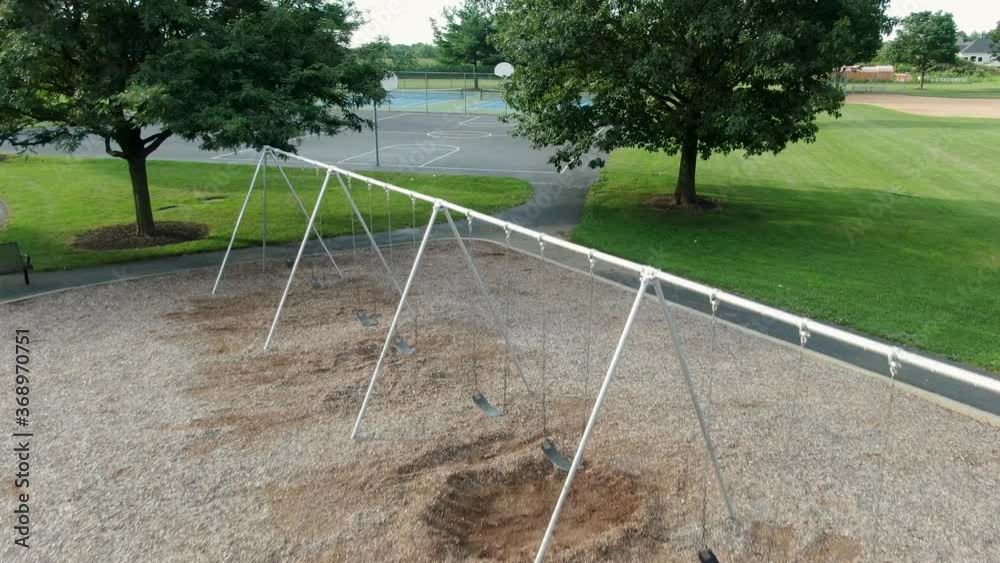 Swingset with multiple swings on school playground, outdoor recess ...