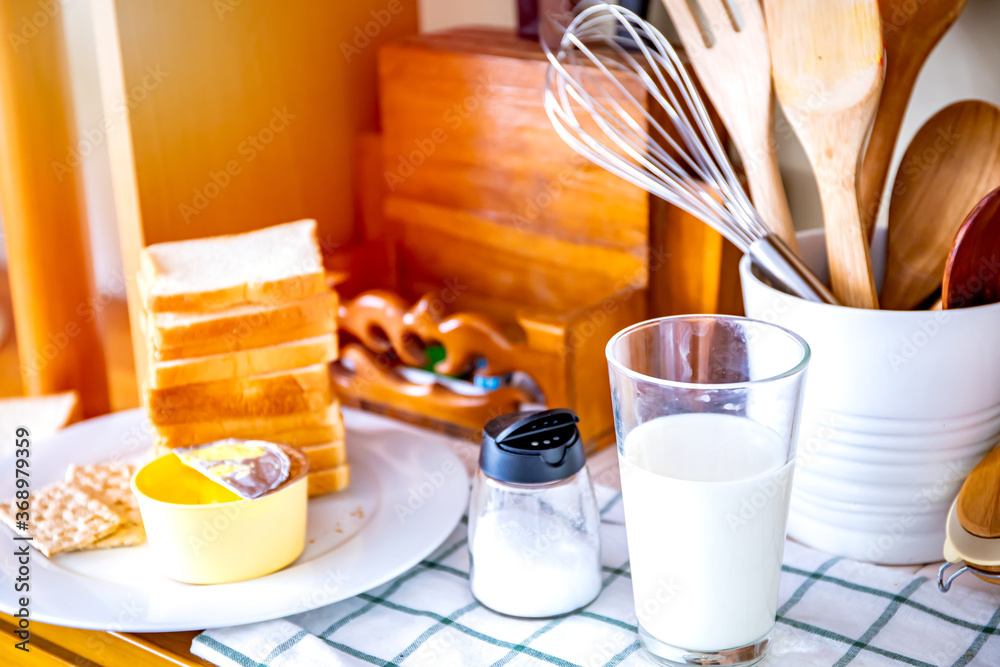 bread-slice-with-butter-put-on-white-dish-with-a-glass-of-milk-put-on