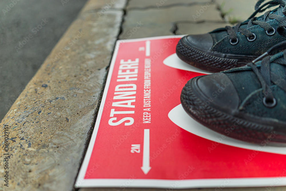 Social distancing sign for people line up in front of grocery store to ...