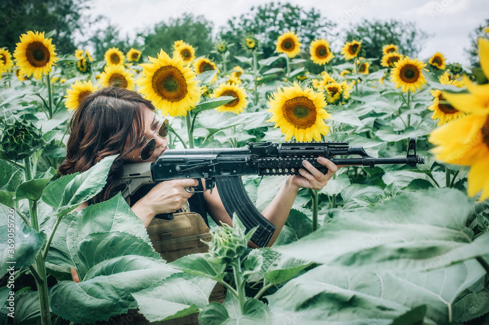 Beautiful and attractive woman soldier with rifle machine gun. Front ...