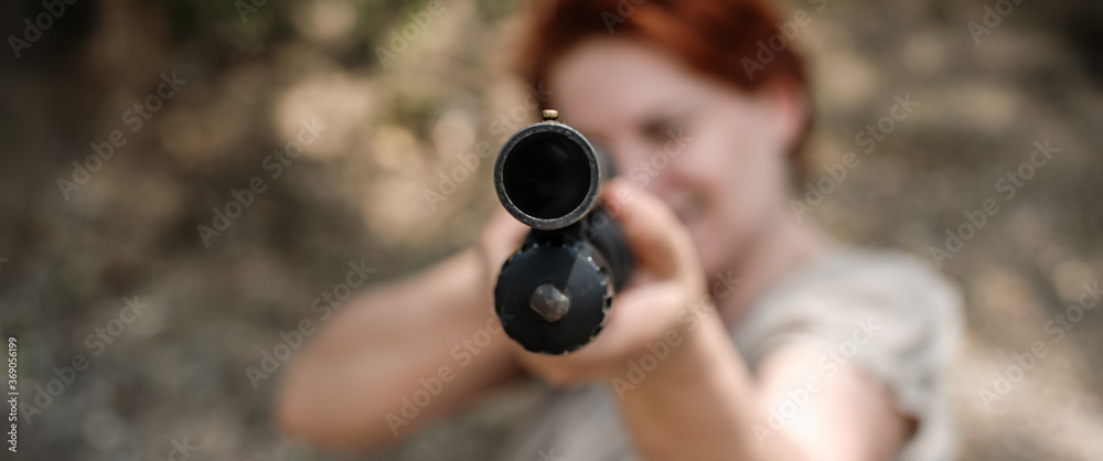 Woman shooting with pump gun. Direct macro detail close-up shotgun ...