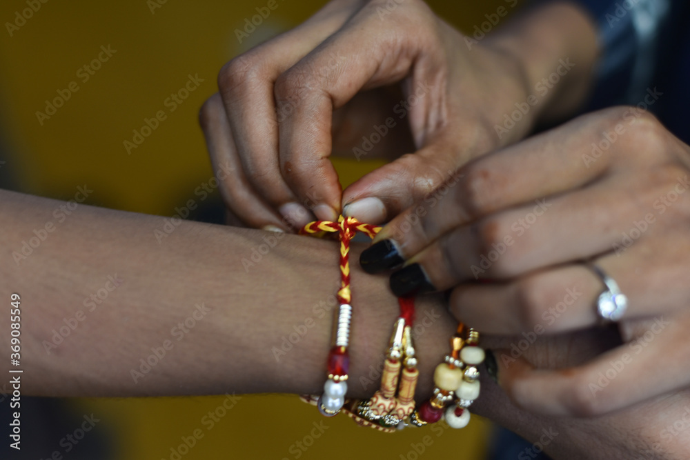 Indian sister tie a traditional rakhi in a brother hand in raksha ...