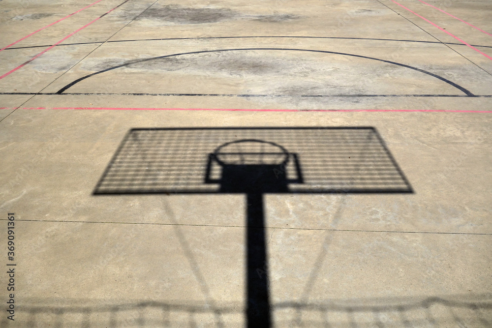 The shadow of a basketball hoop on a beach basketball court Stock Photo ...