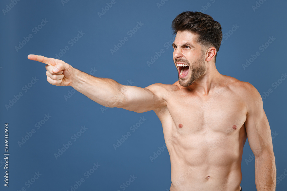 Angry young bearded fitness sporty strong guy bare-chested muscular ...