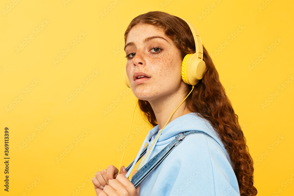 Beautiful young woman portrait over yellow background. Stock Photo ...