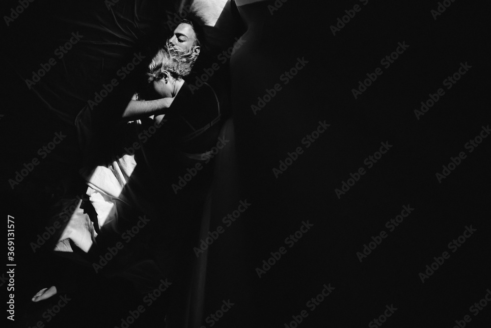 Couple in love sleeping in the bed in dark room Stock Photo | Adobe Stock