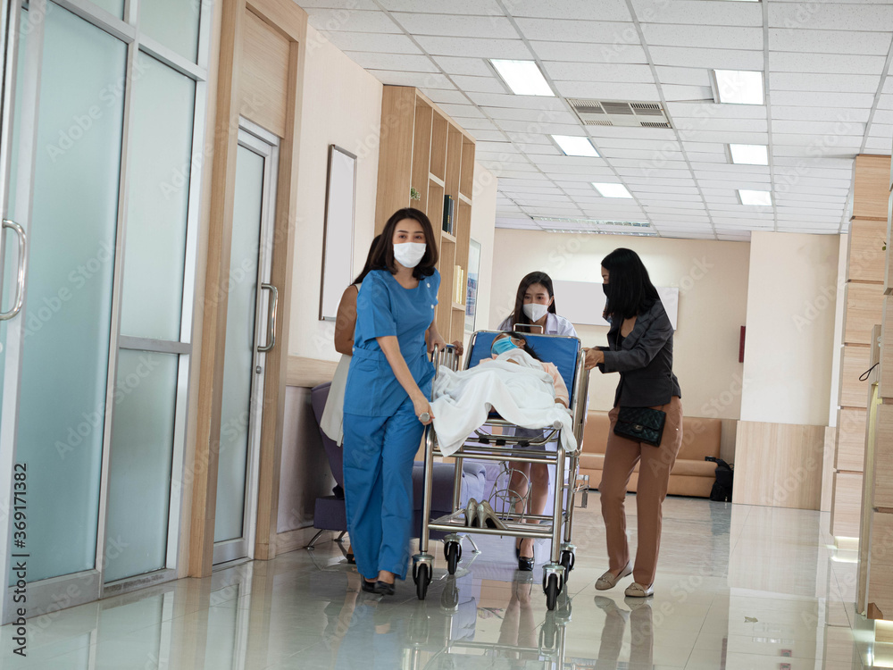hospital emergency room male doctor and female nurse run hallway ...