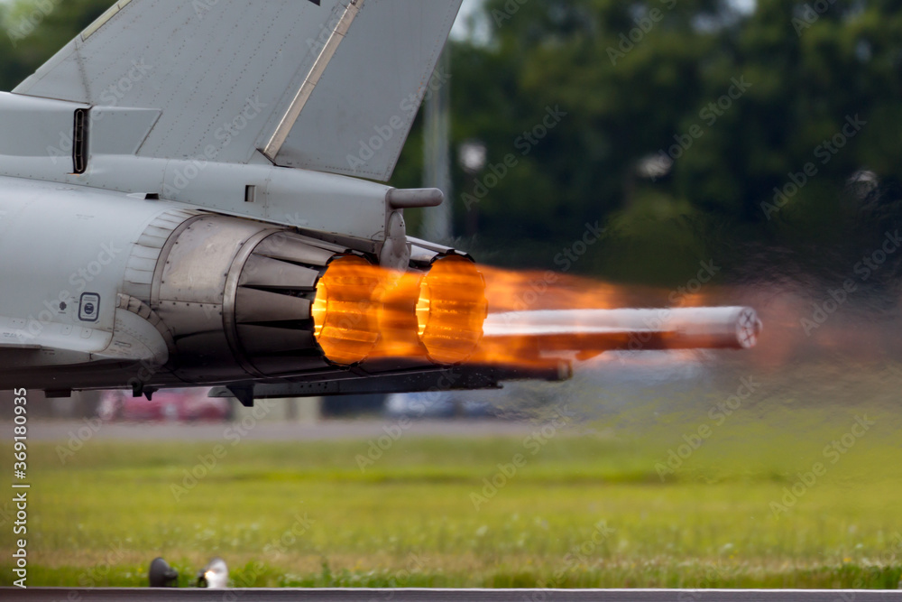 Afterburners glowing on an air force fighter jet aircraft as it speeds ...