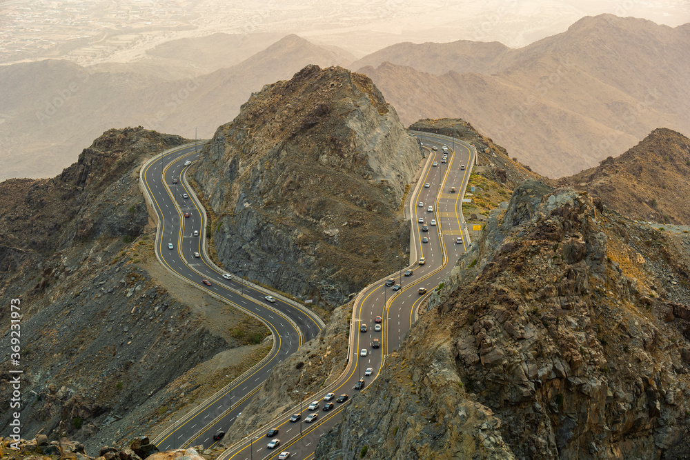 Traffic travelling around mountain pass on the zig zag road in Al Hada ...