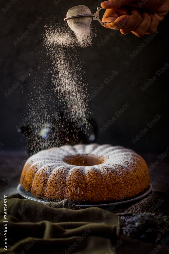 When pouring powdered sugar on the cake Stock Photo | Adobe Stock