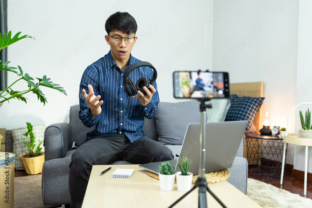 Asian man technology blogger or Social media influencer presenting and ...