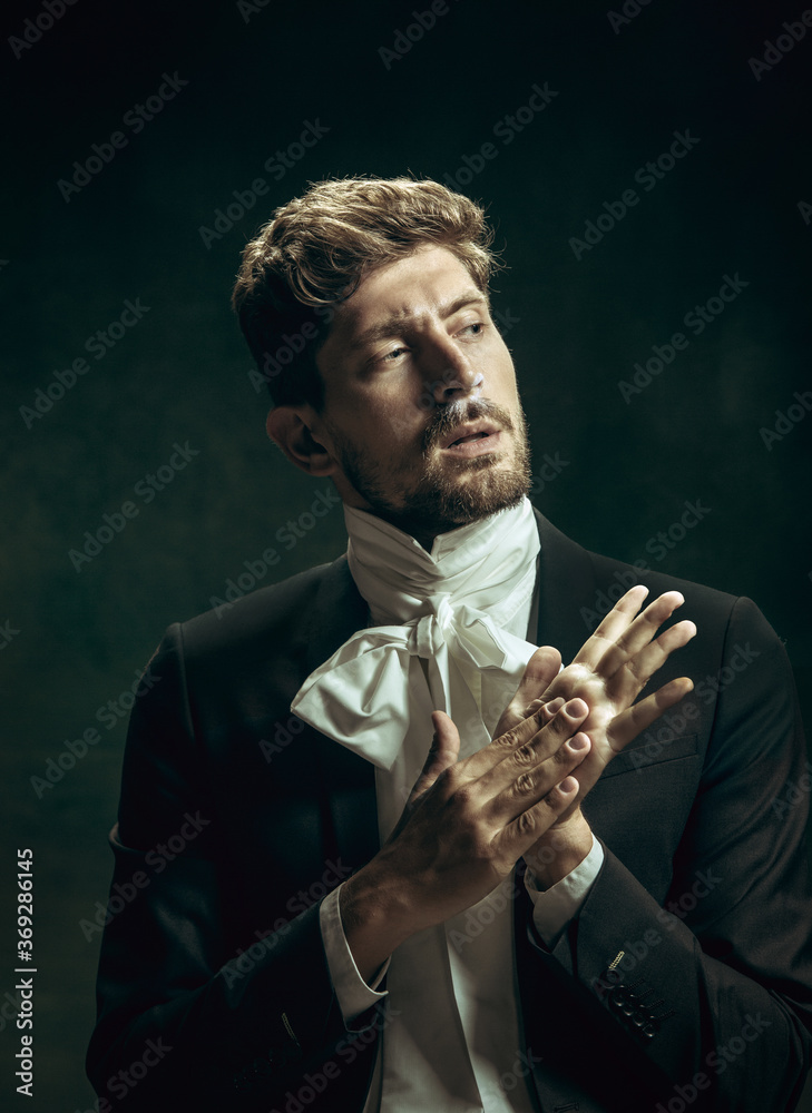 Opium. Young man in suit as Dorian Gray isolated on dark green ...