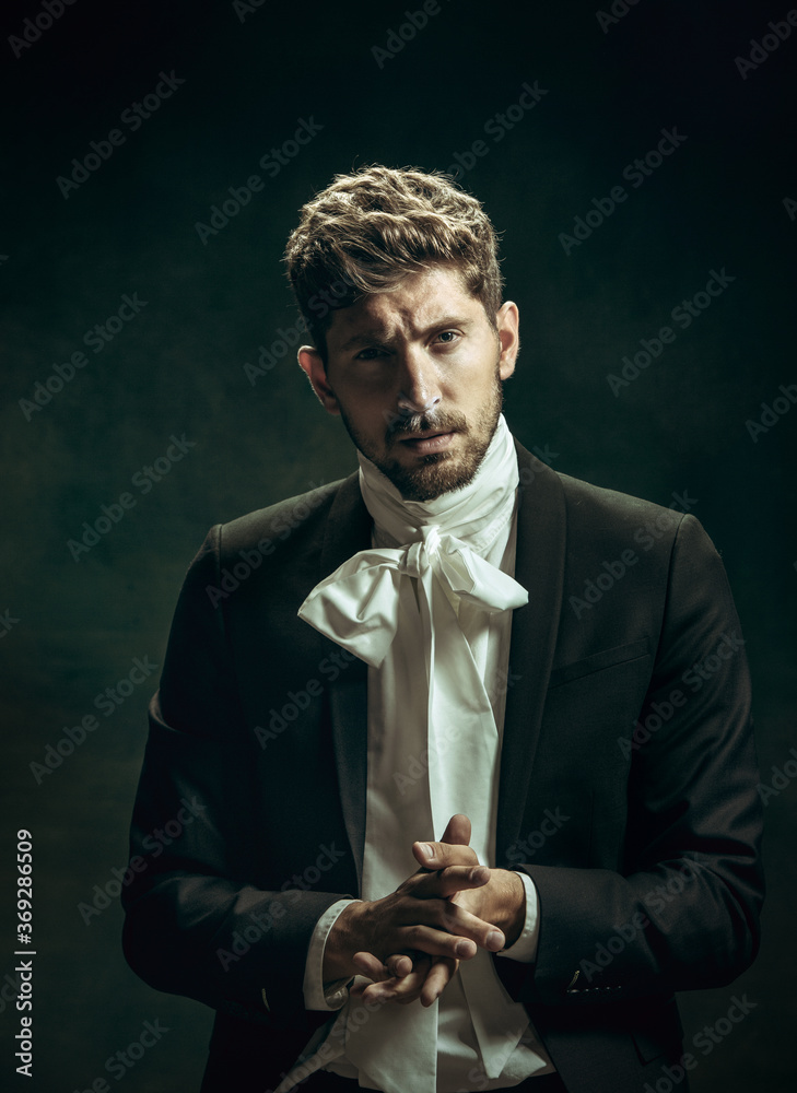 Opium. Young man in suit as Dorian Gray isolated on dark green ...