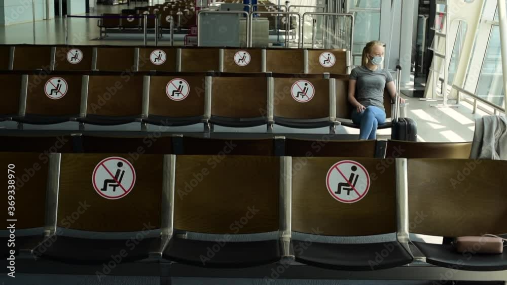 Woman tourist wearing medical protection mask using mobile phone in ...