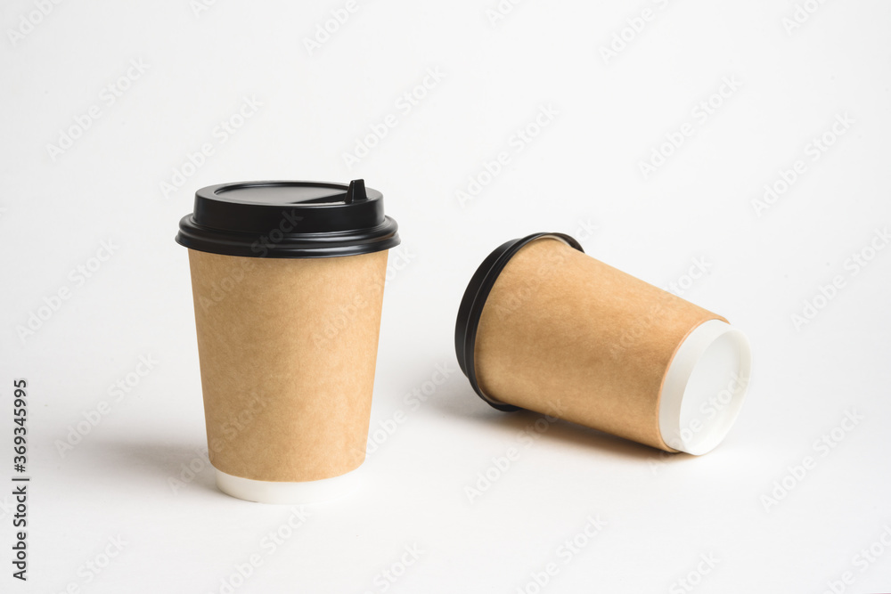 Two eco friendly paper craft cups for coffee with black lid on the ...