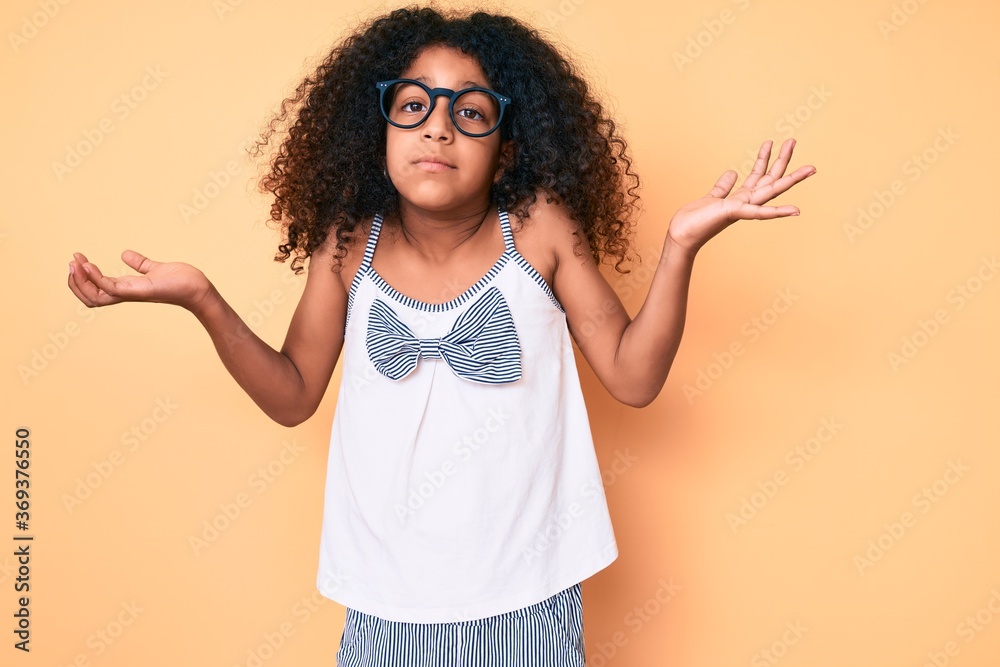 African american child with curly hair wearing casual clothes and ...