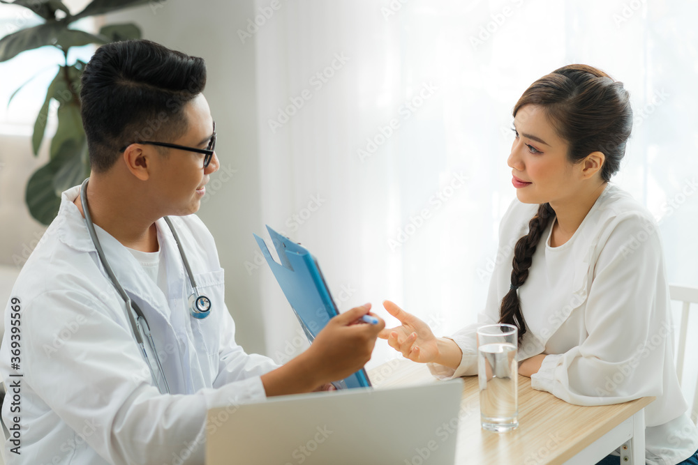 Male Obstetrician-gynecologist working with young stress woman in ...