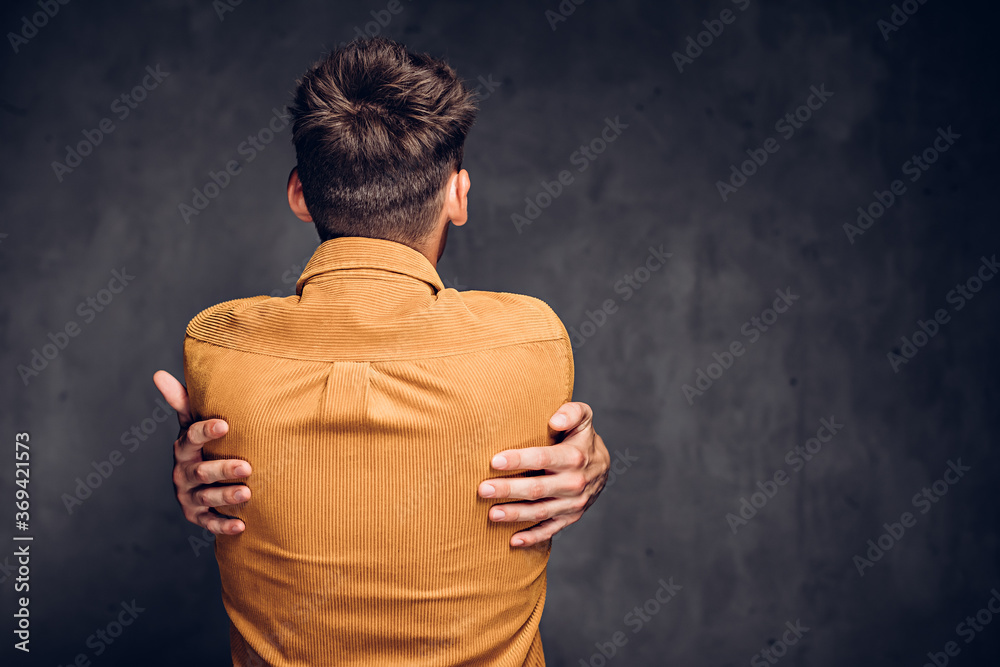 Back view of man clenched hands on dark background Stock Photo | Adobe ...