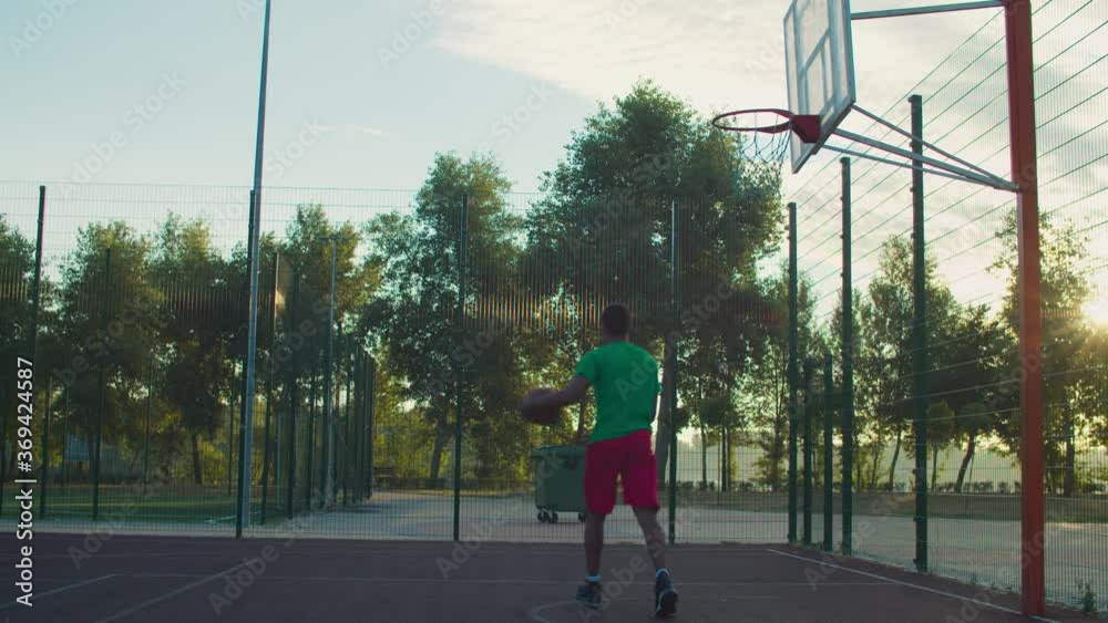 Skillful handsome african american basketball player driving to the ...