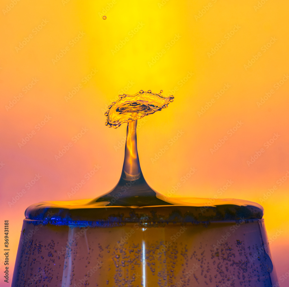 Water Drop Collisions Macro Photography with orange background Stock ...