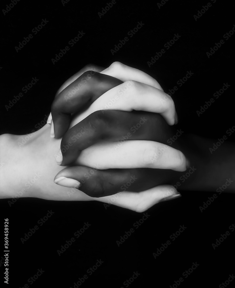 Monochromatic photo for two black & white hands with different ...