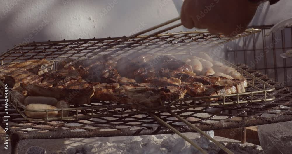 Barbecue: Barbecue/braai on a grid above charcoals. Meat (pork sausages ...