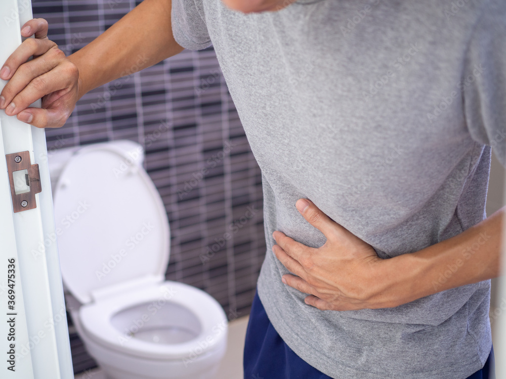Foto de Men are standing in front of the bathroom door using their ...
