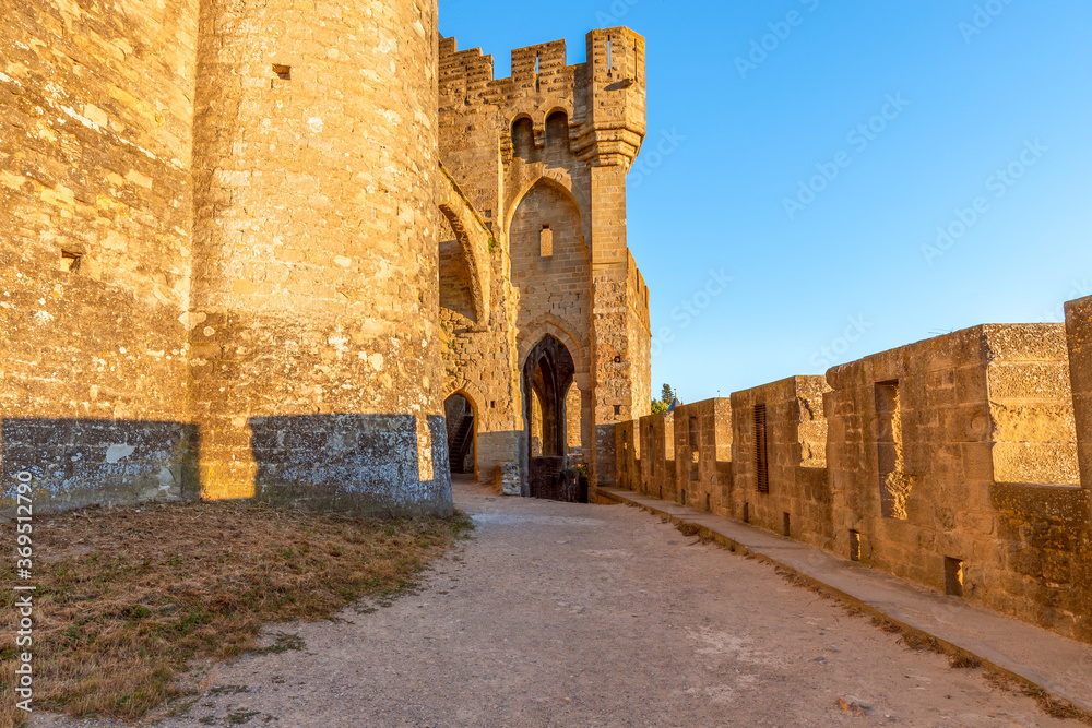 Wide fortified walls with walkways and arches of medieval castle of ...