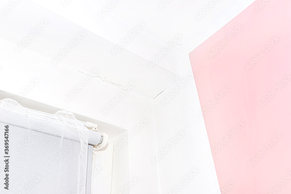 Longitudinal crack in the lintel wall above the window inside the ...