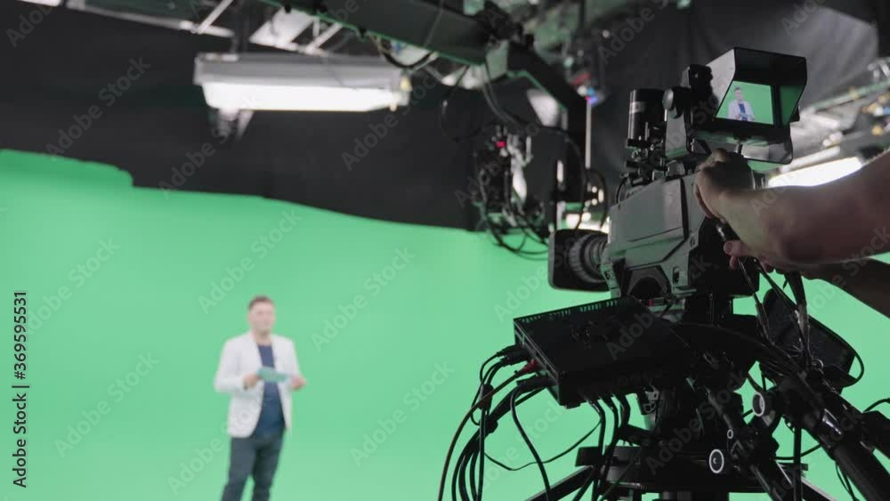 Film crew in green studio shooting video. Chroma - technology of ...