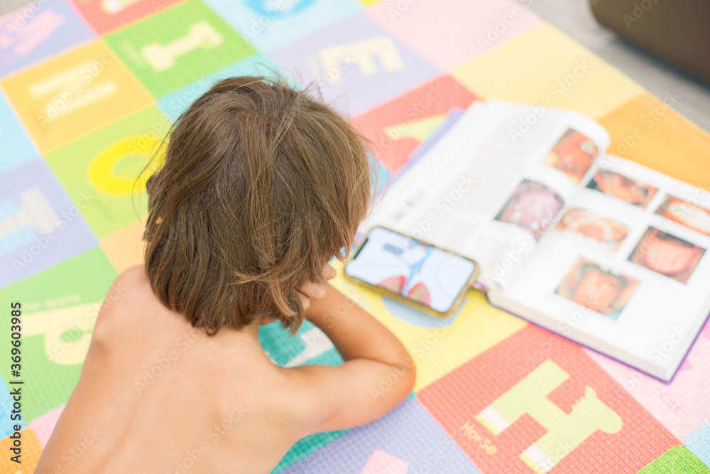 Young boy child fascinated learning about the human body mouth lungs ...