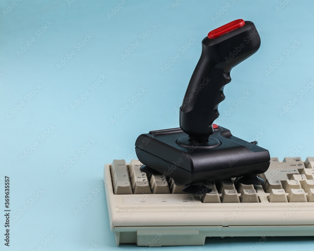 Retro joystick on old pc keyboard. Blue background. Attributes 80s ...
