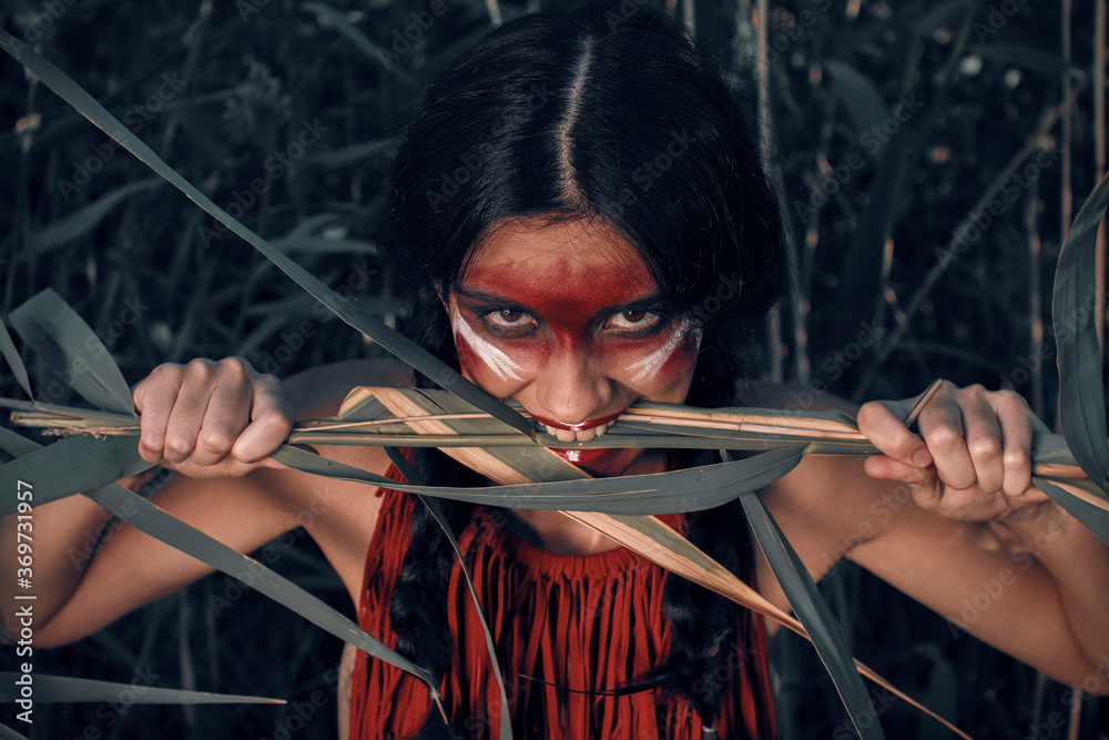red-skinned Indian girl with red makeup on her face posing in yellow ...
