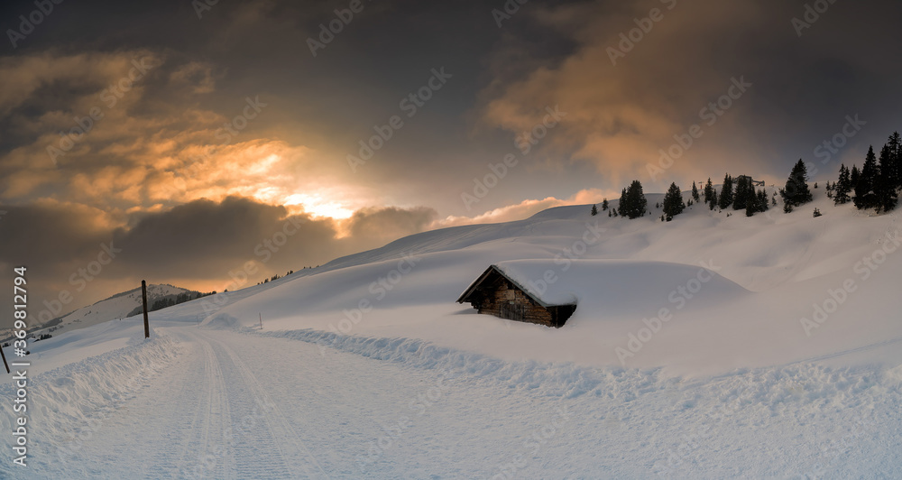 Snowy landscape with house buried in snow during sunset with frozen ...