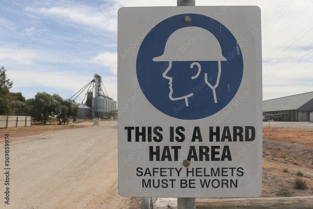 blue and white This Is A Hard Hat Area sign warning that Safety Helmets ...