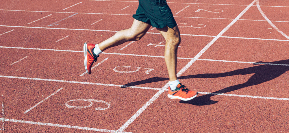 Man crossing the finish line at the track. Concept achieving objectives ...
