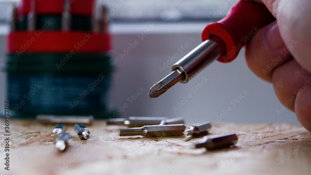 A set of small screwdrivers. A nozzle on a small screwdriver close-up ...