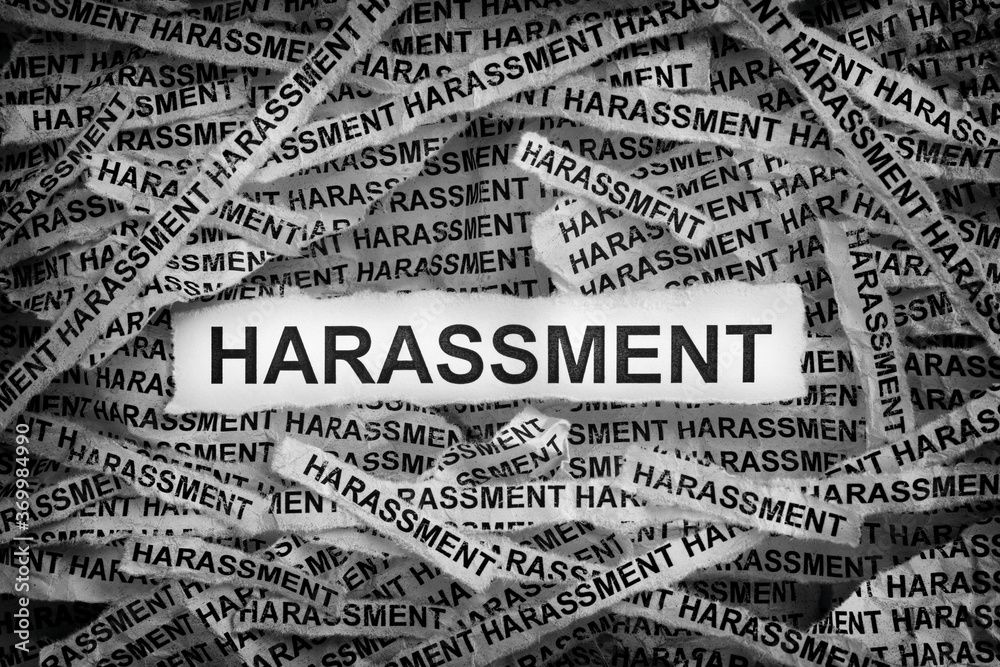 Harassment. Torn pieces of paper with the word Harassment. Concept ...