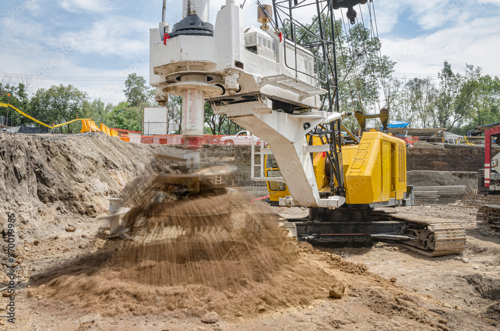 Drilling tractor vehicle in construction site Driller removing earth ...