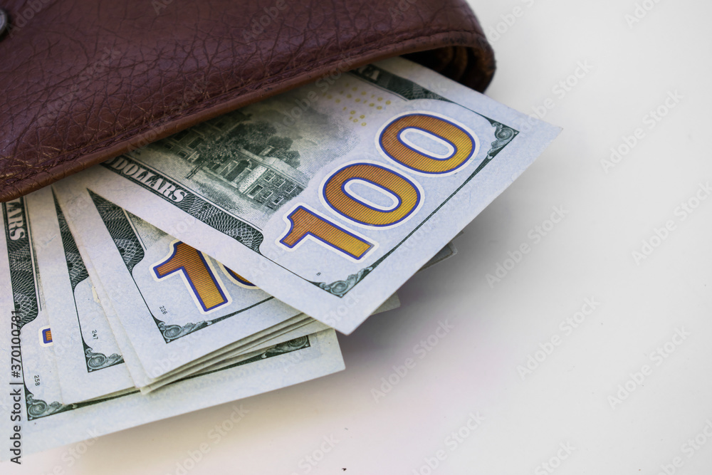 on the top left is a closed men's wallet with dollars sticking out of ...