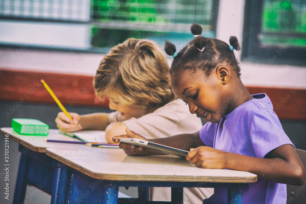 African girl and caucasian boy studying in the classroom Stock Photo ...