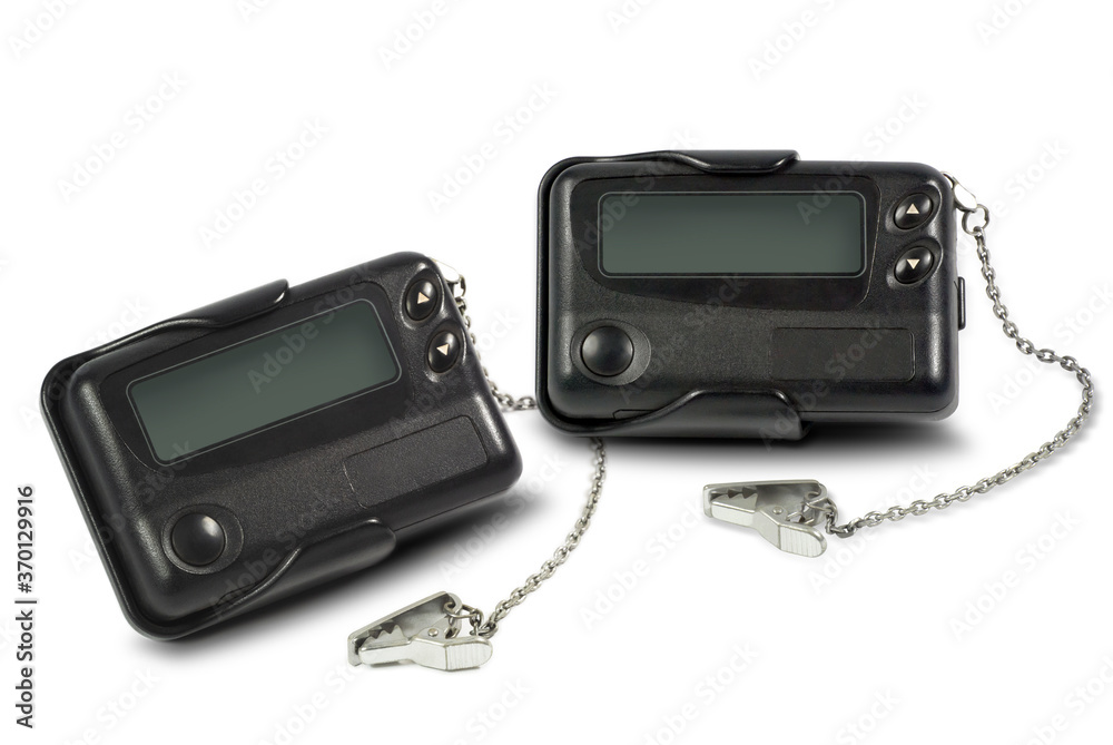 Two old pager or two beeper isolated on white background horizontal view with clipping path ...