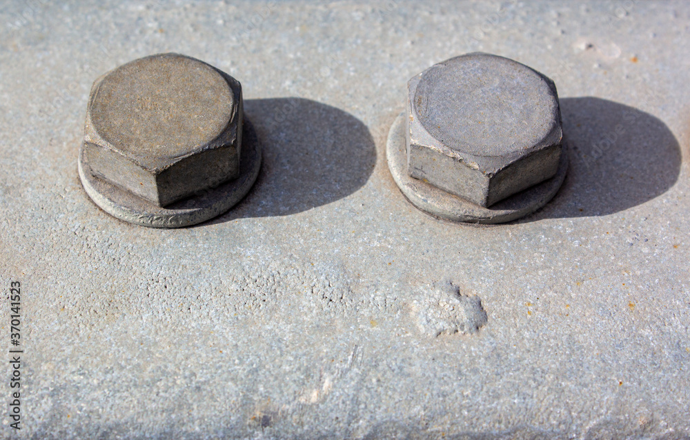 Large head bolts on metal construction as background - engineering ...
